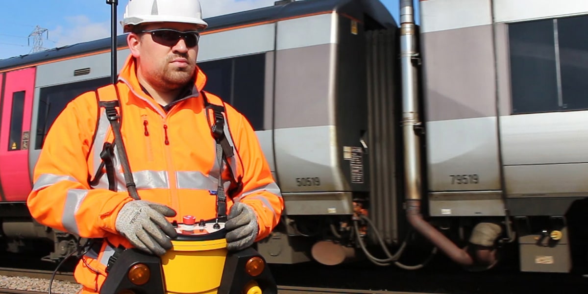 Why is the LOWS system used on the UK rail infrastructure?